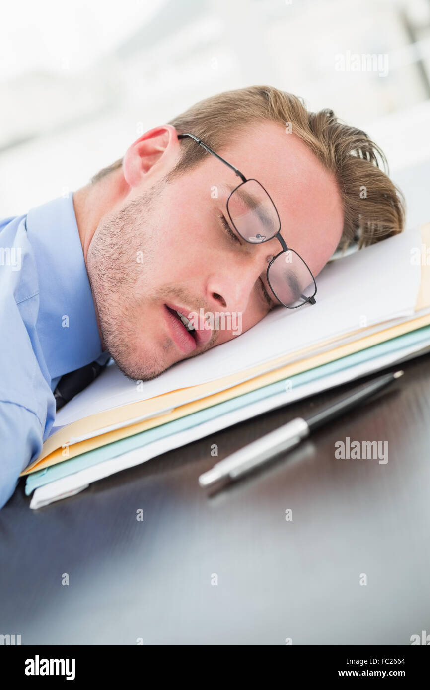 Tired businessman with stack of files on desk Stock Photo - Alamy