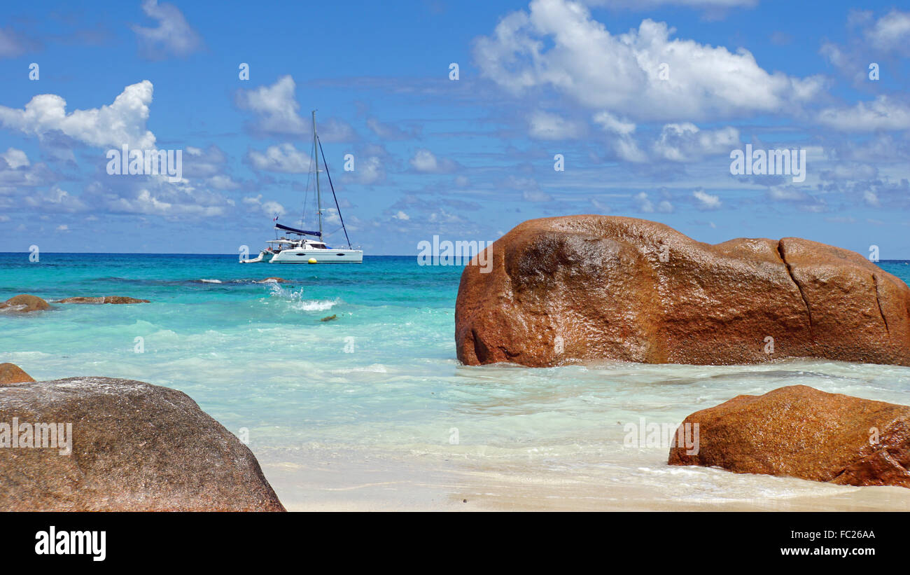 granite rocks and catamaran on seychelles Stock Photo - Alamy