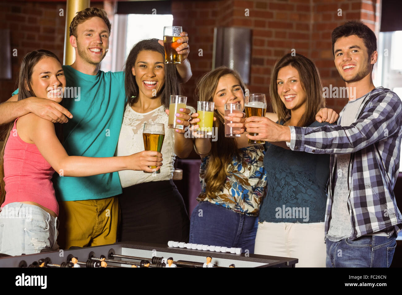 Portrait of happy friends toasting with mixed drink and beer Stock ...