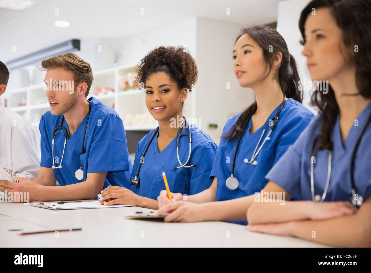 Medical student smiling at the camera during class Stock Photo - Alamy