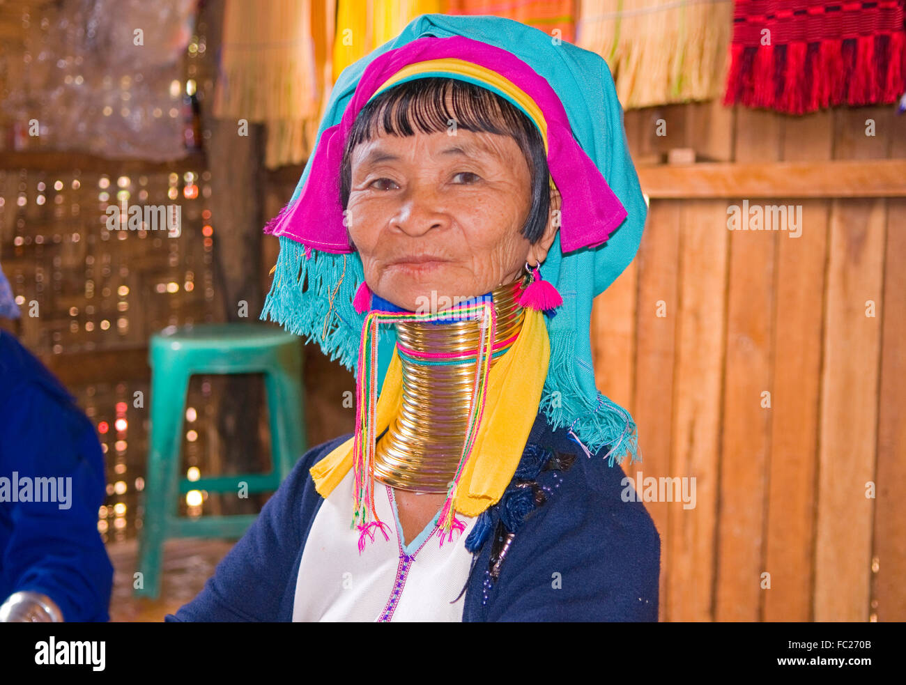 A woman wearing her traditional head scarf and neck rings from Inle ...