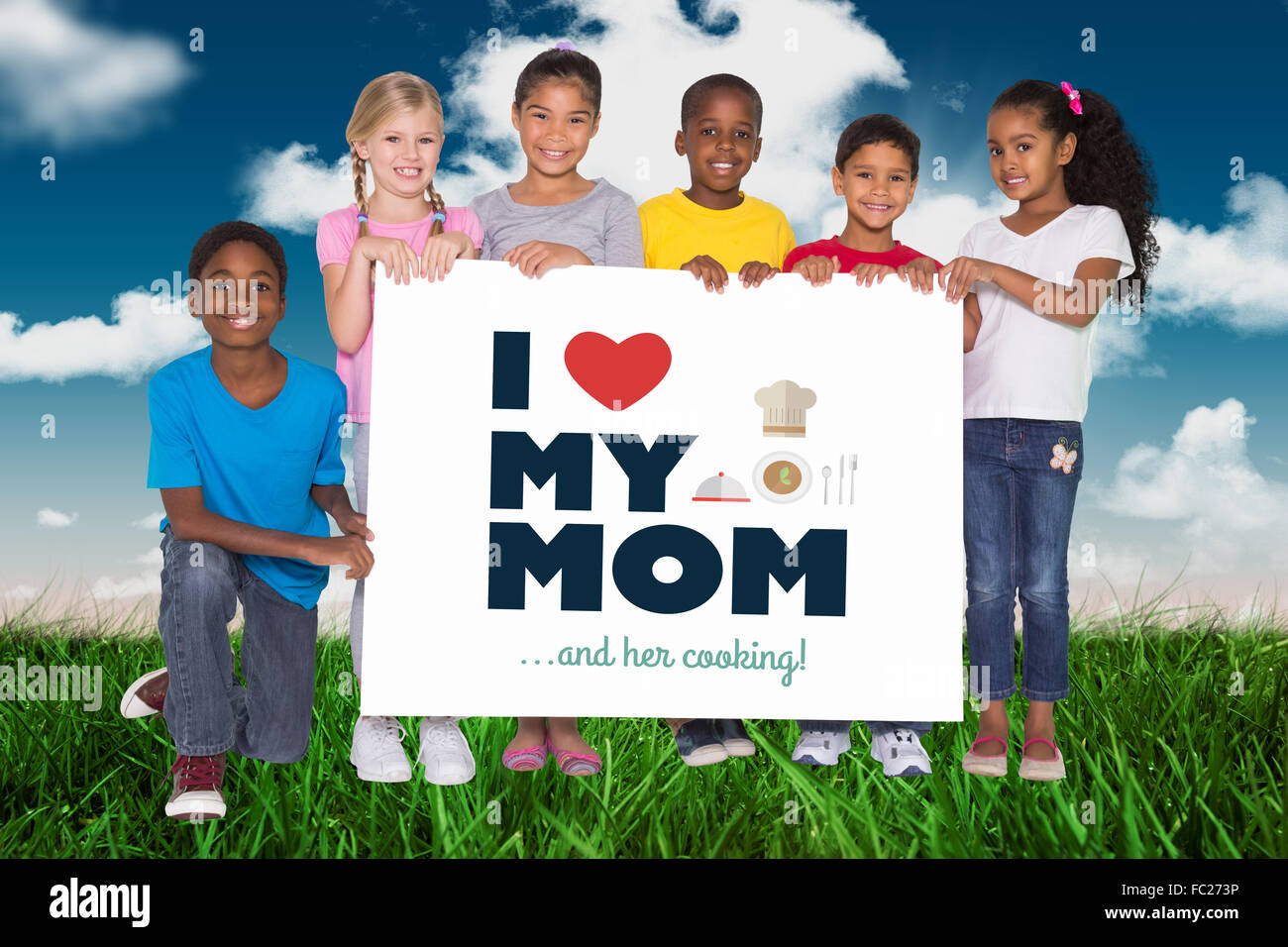 Composite image of elementary pupils showing card Stock Photo - Alamy