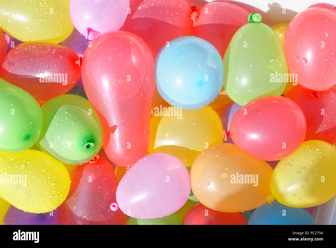 Colorful balloons with water drops Stock Photo - Alamy