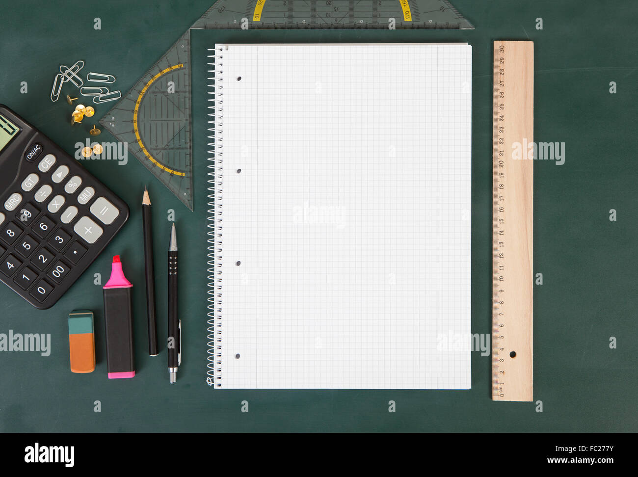 a school board with notebook, ruler and set square, next to a ...