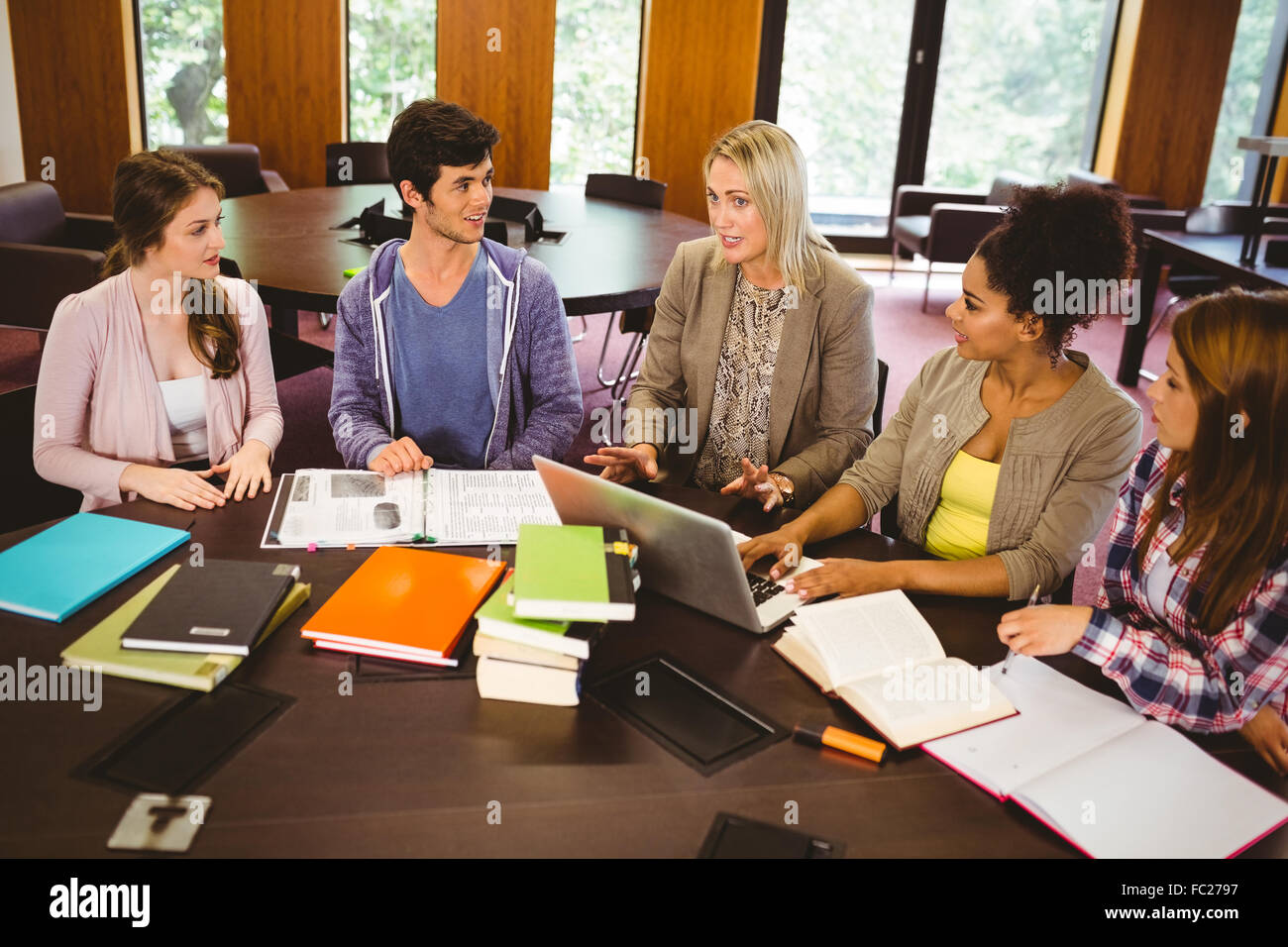 Smiling students working together on an assignment Stock Photo - Alamy