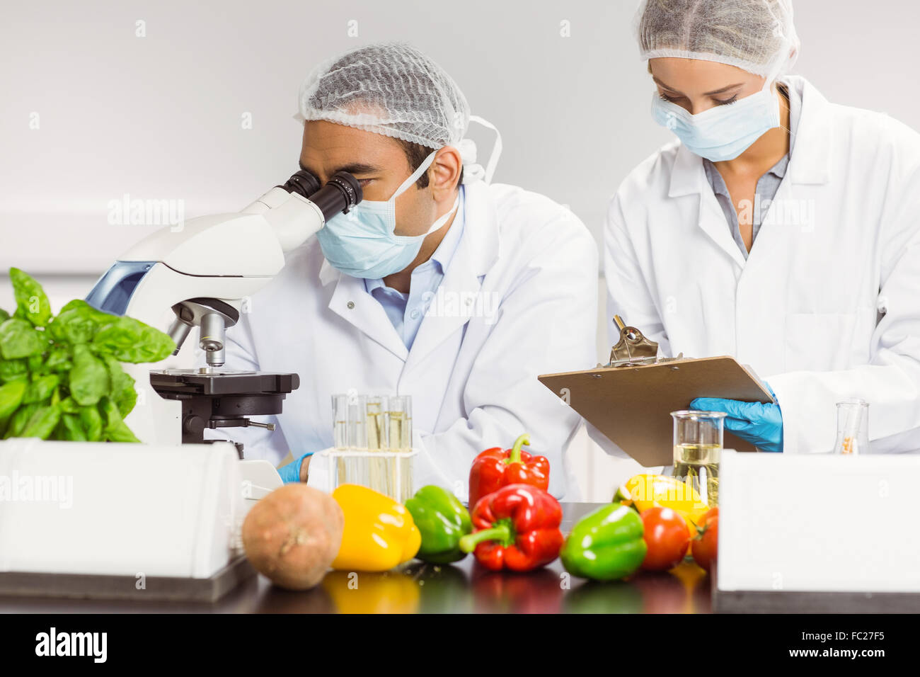 Food scientists using the microscope for research Stock Photo - Alamy