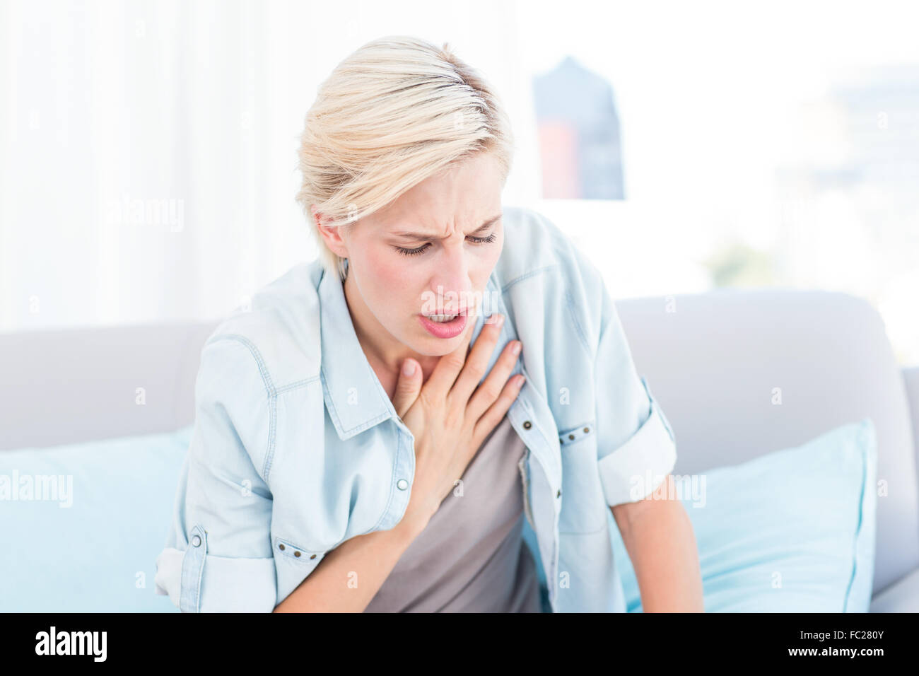 Pretty blonde woman having breath difficulties Stock Photo - Alamy