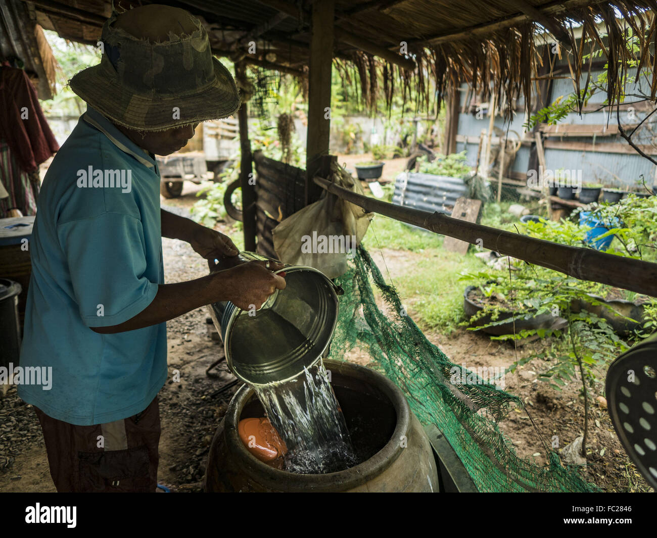 Si Liam, Buri Ram, Thailand. 20th Jan, 2016. A man fills his home water ...
