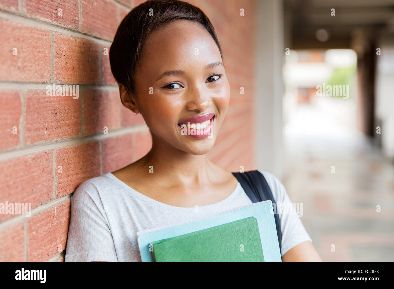 gorgeous African college student with books on campus Stock Photo - Alamy