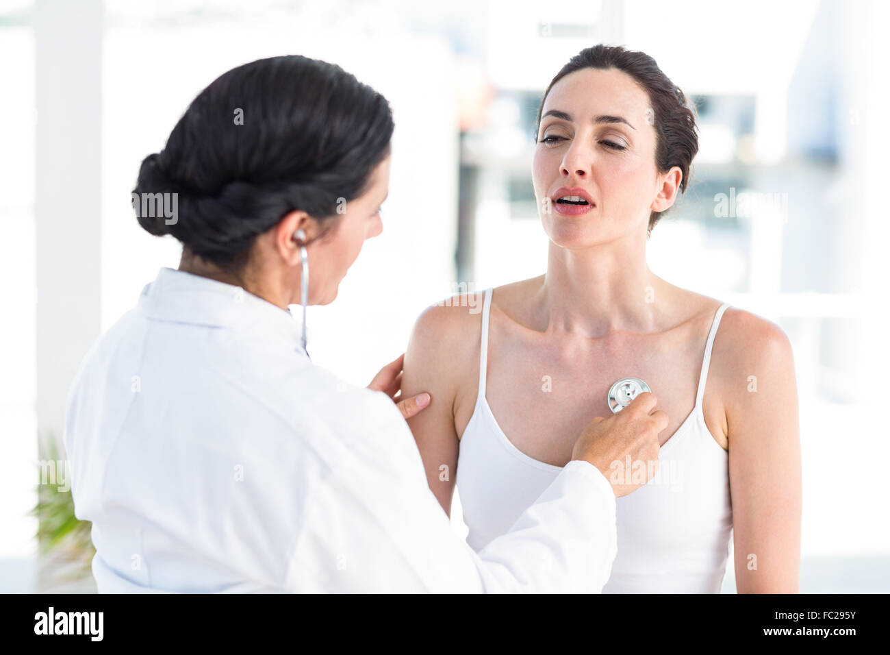 Doctor listening to patients chest with stethoscope Stock Photo - Alamy