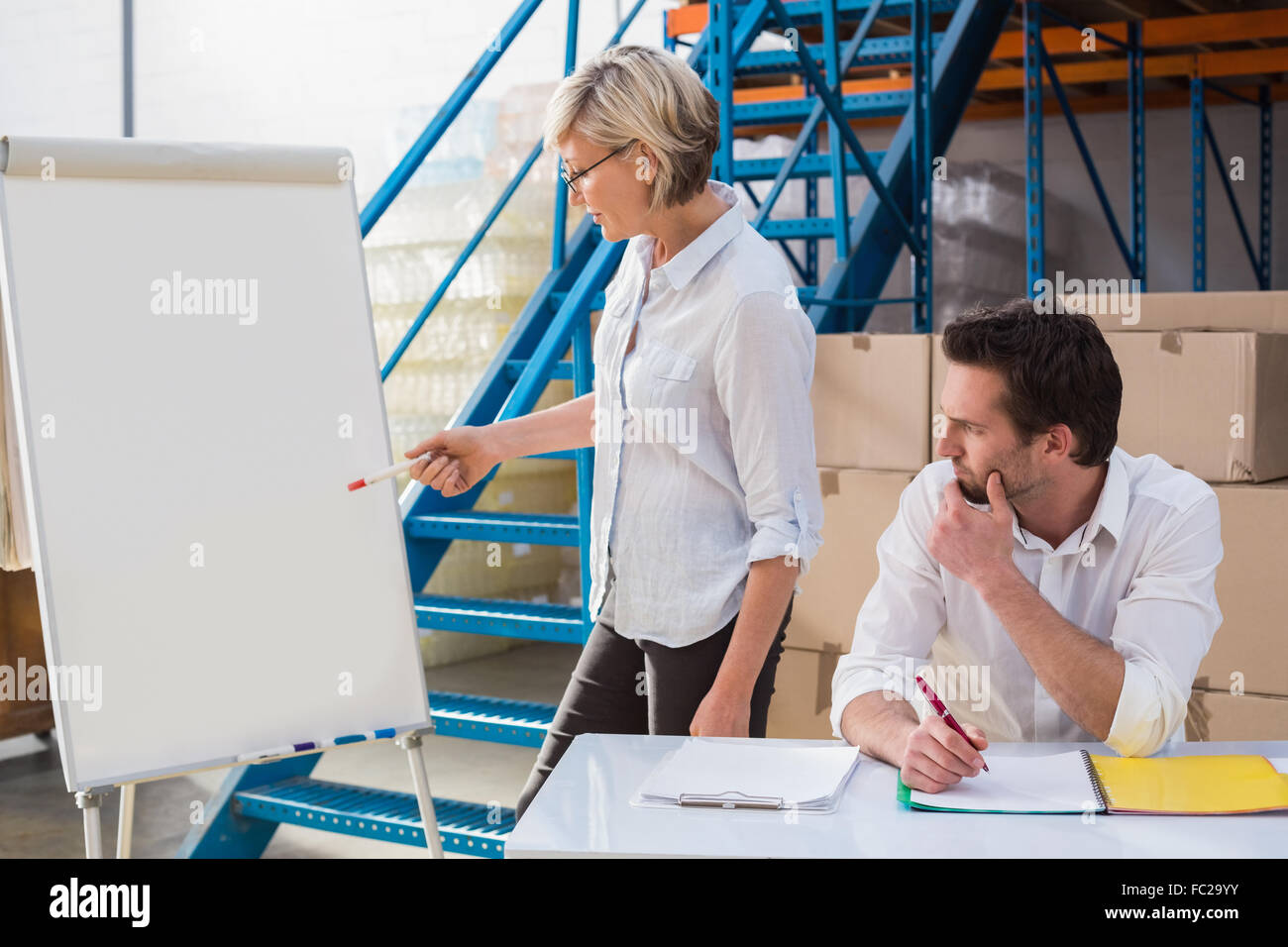 Focused manager taking notes during presentation Stock Photo - Alamy