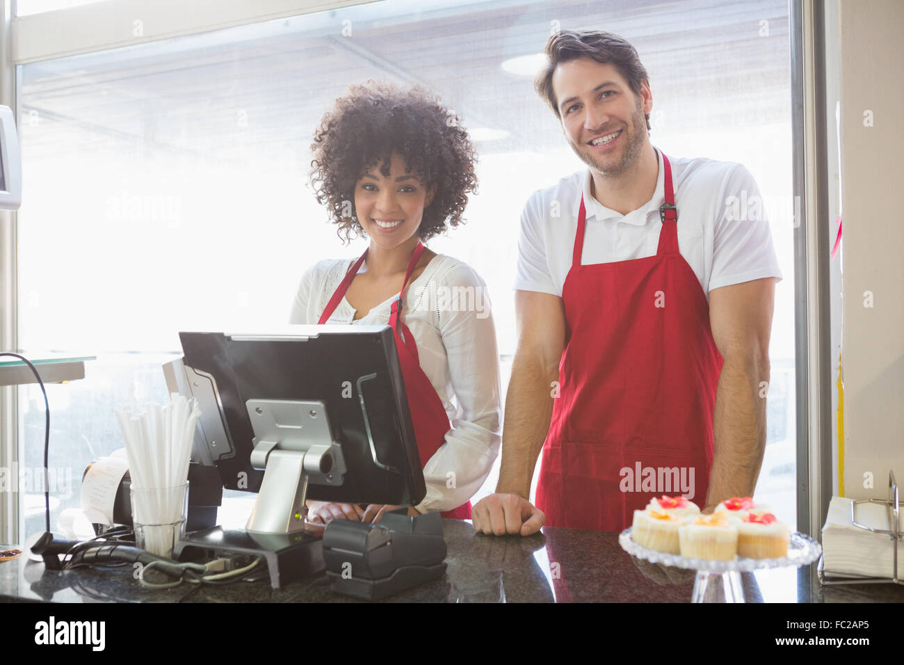 Woman smiling behind bakery counter hi-res stock photography and images ...