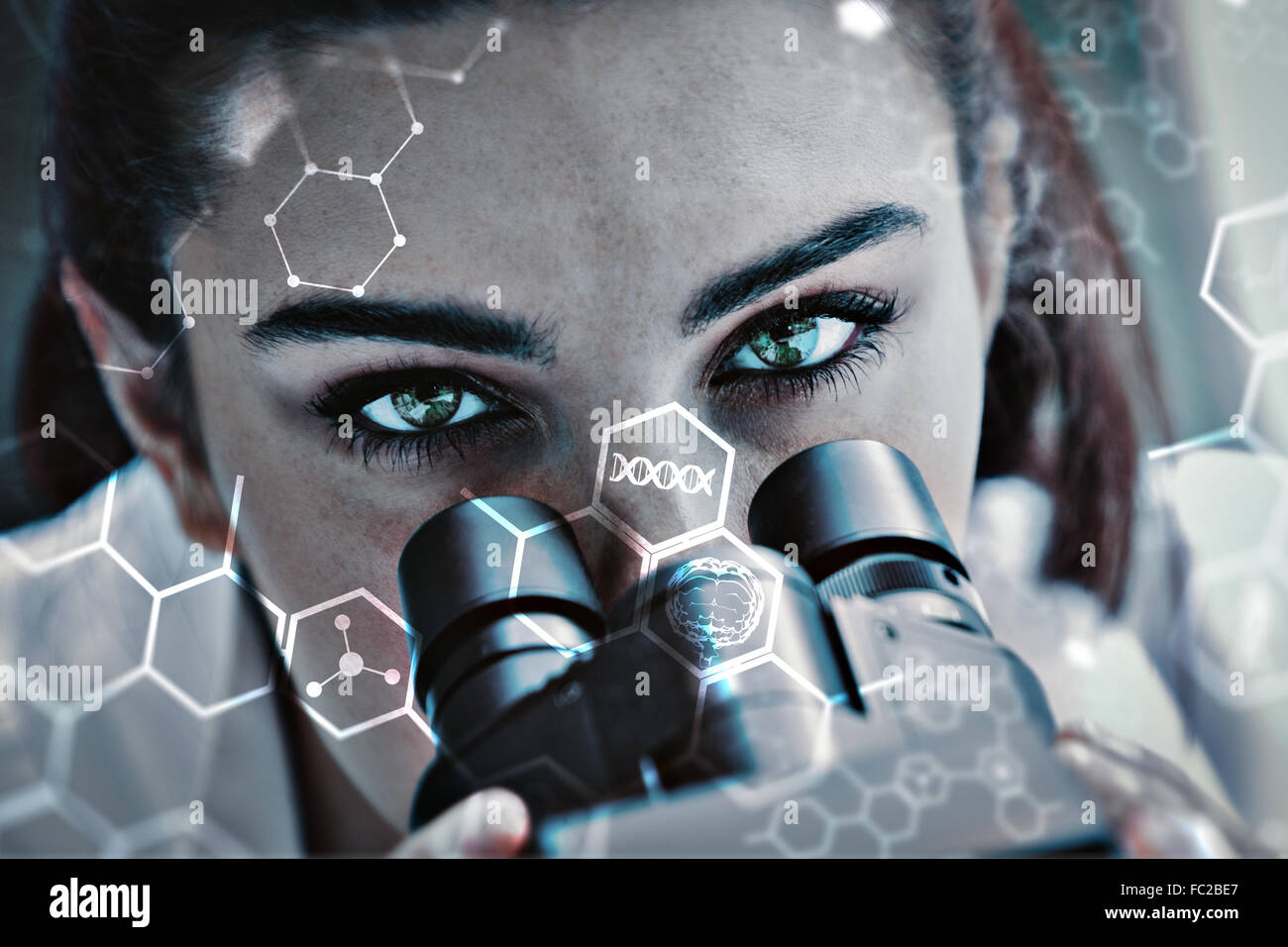 Woman watching through microscope hi-res stock photography and images ...