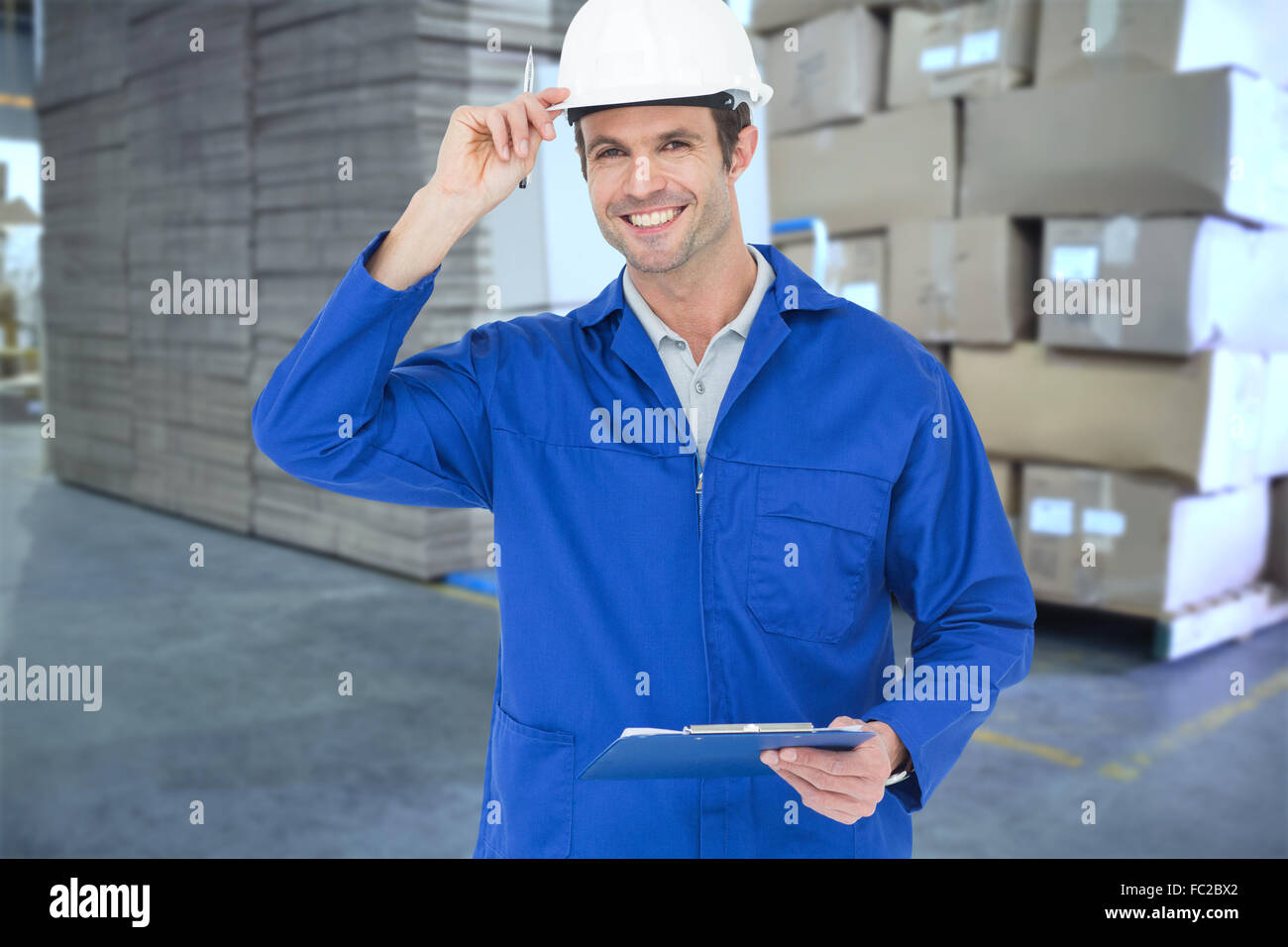 Composite image of happy supervisor wearing hard hat while holding clip ...