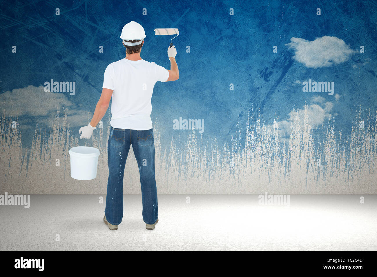 Composite image of rear view of man using paint roller Stock Photo - Alamy