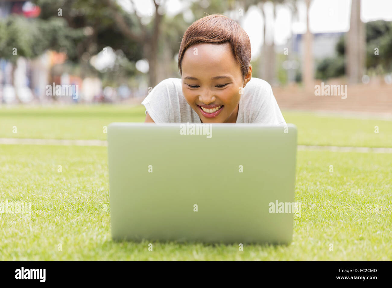 cheerful African college student using laptop outdoors Stock Photo - Alamy