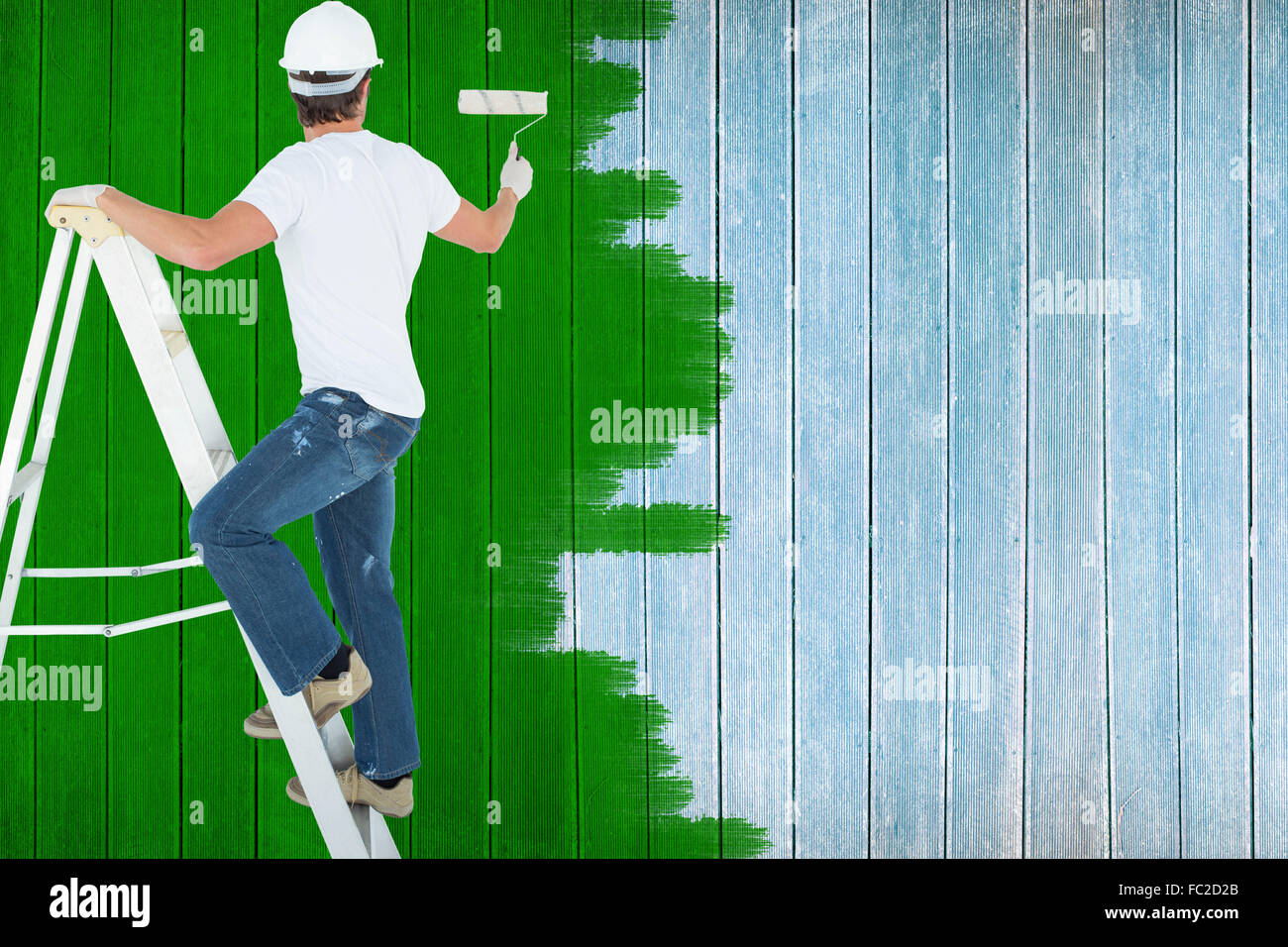 Composite image of man on ladder painting with roller Stock Photo - Alamy