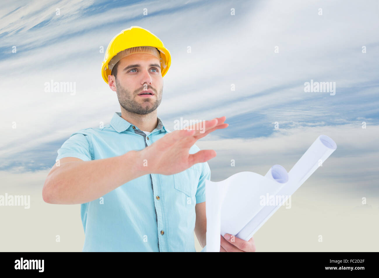 Composite image of architect with blueprint gesturing on white ...