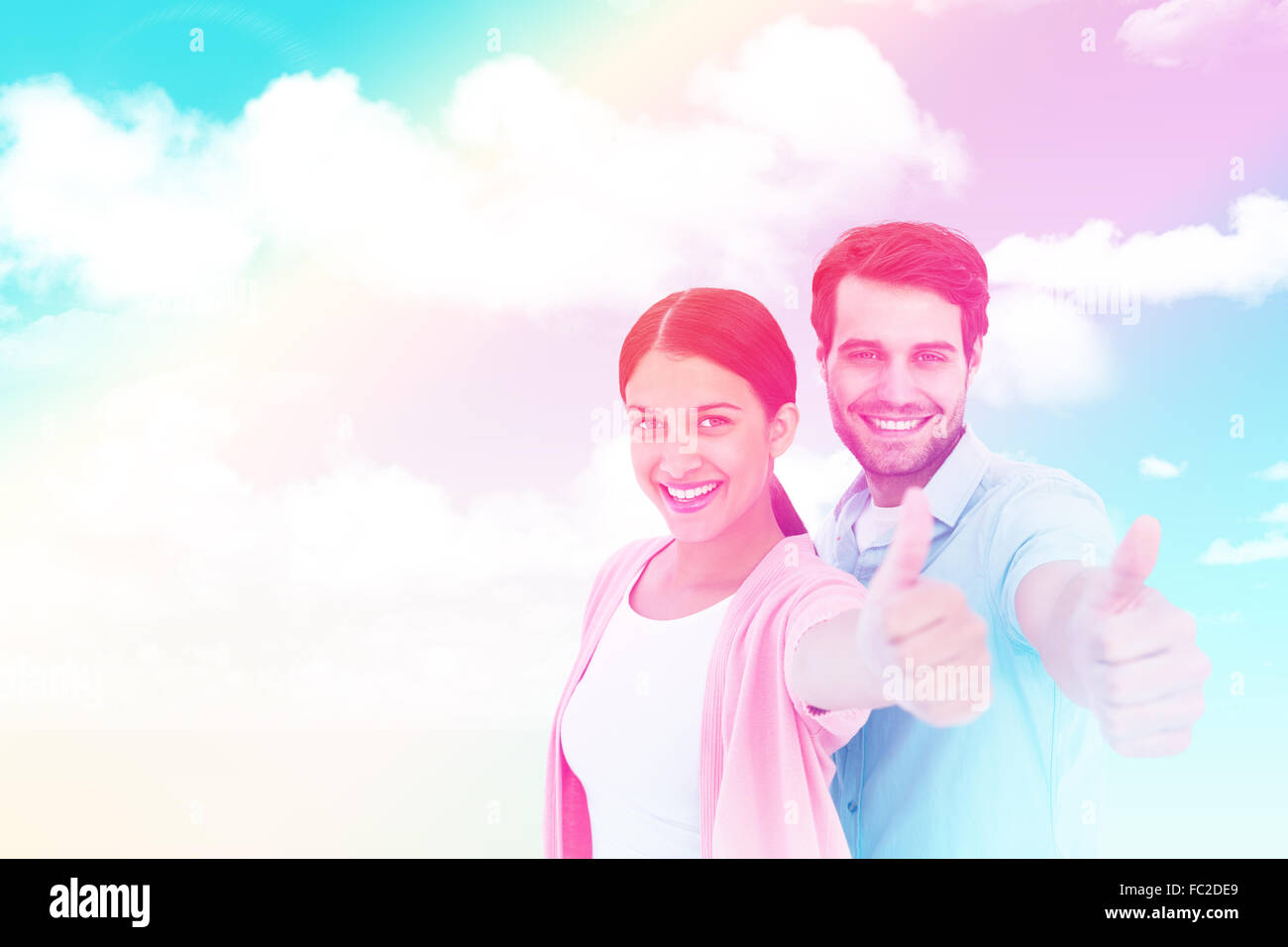 Composite image of happy couple showing thumbs up Stock Photo - Alamy