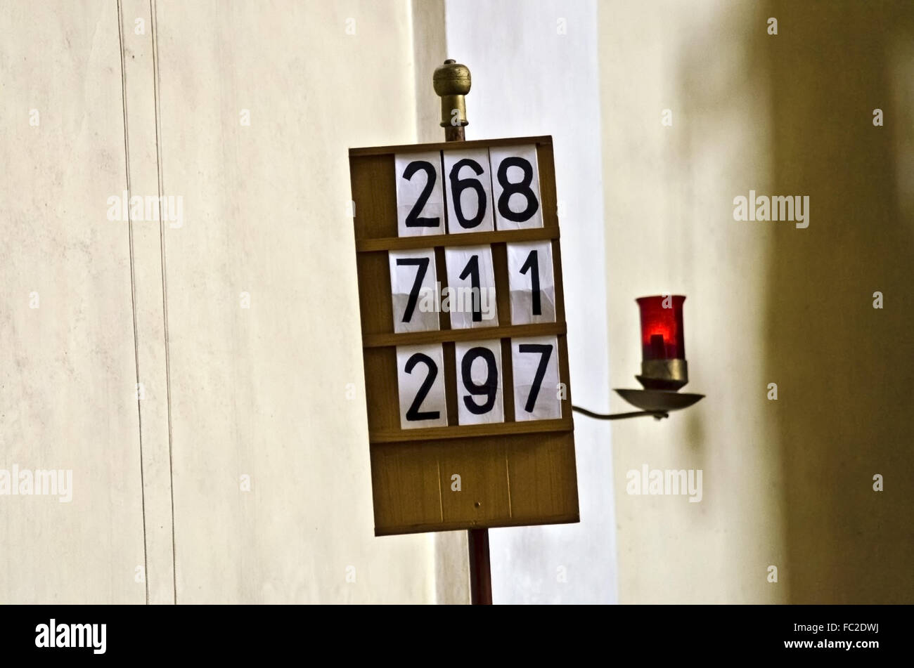 hymn board and red eternal light Stock Photo - Alamy