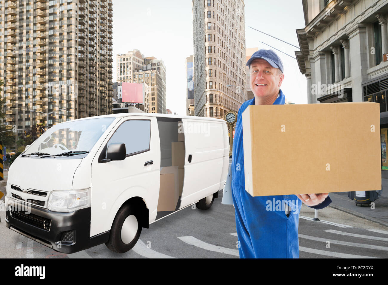 Composite image of happy delivery man showing cardboard box Stock Photo ...