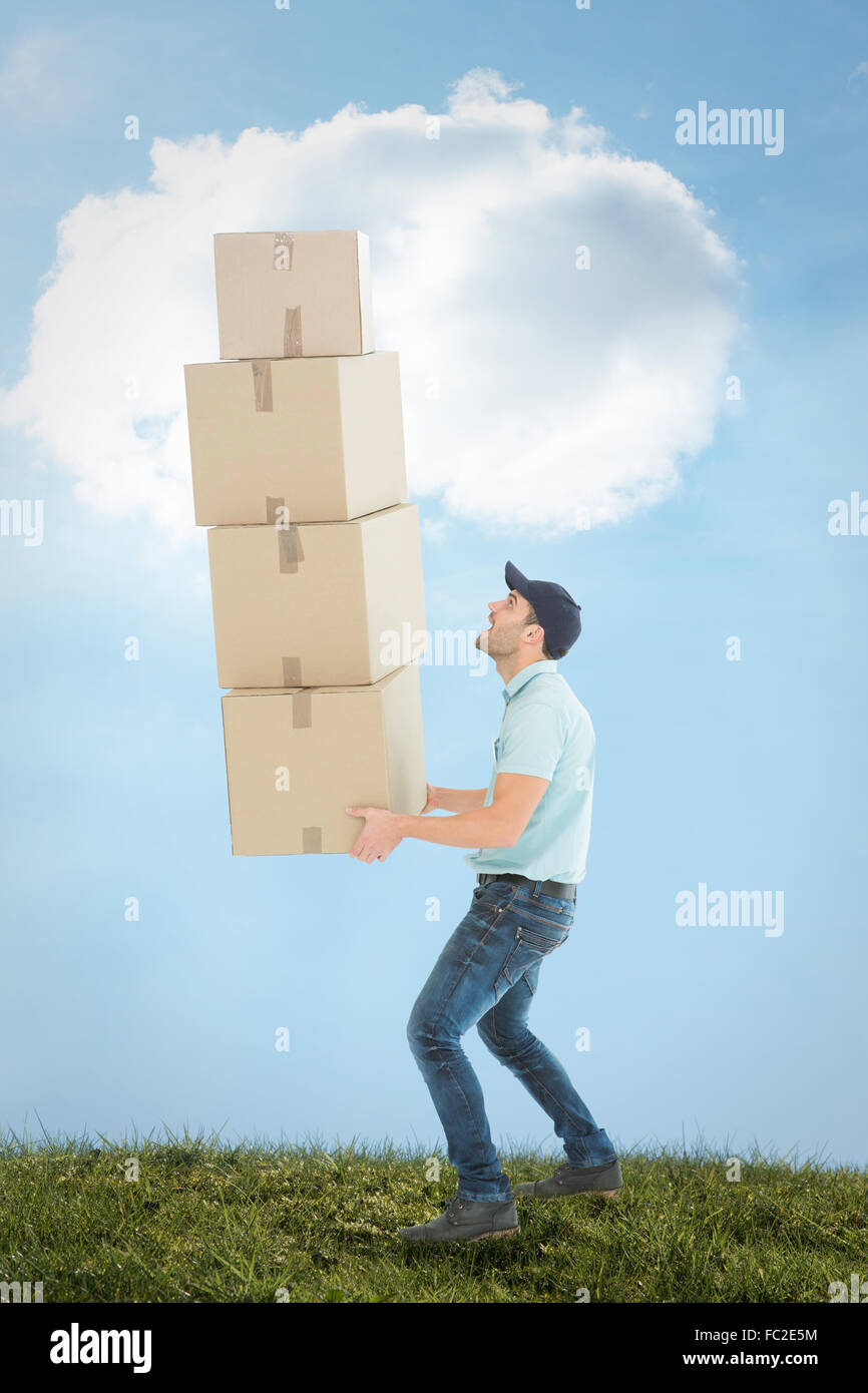 Composite image of shocked delivery man carrying stack of boxes Stock ...