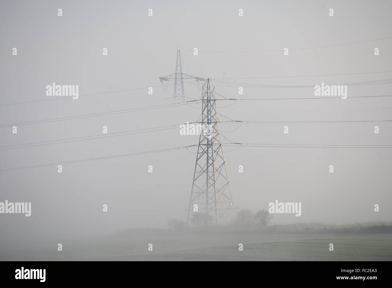 Electricity pylons in the fog Stock Photo - Alamy