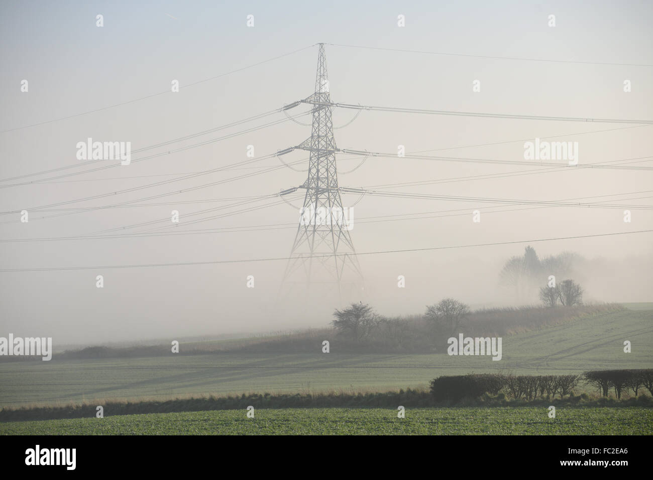Electricity pylon in the fog Stock Photo - Alamy
