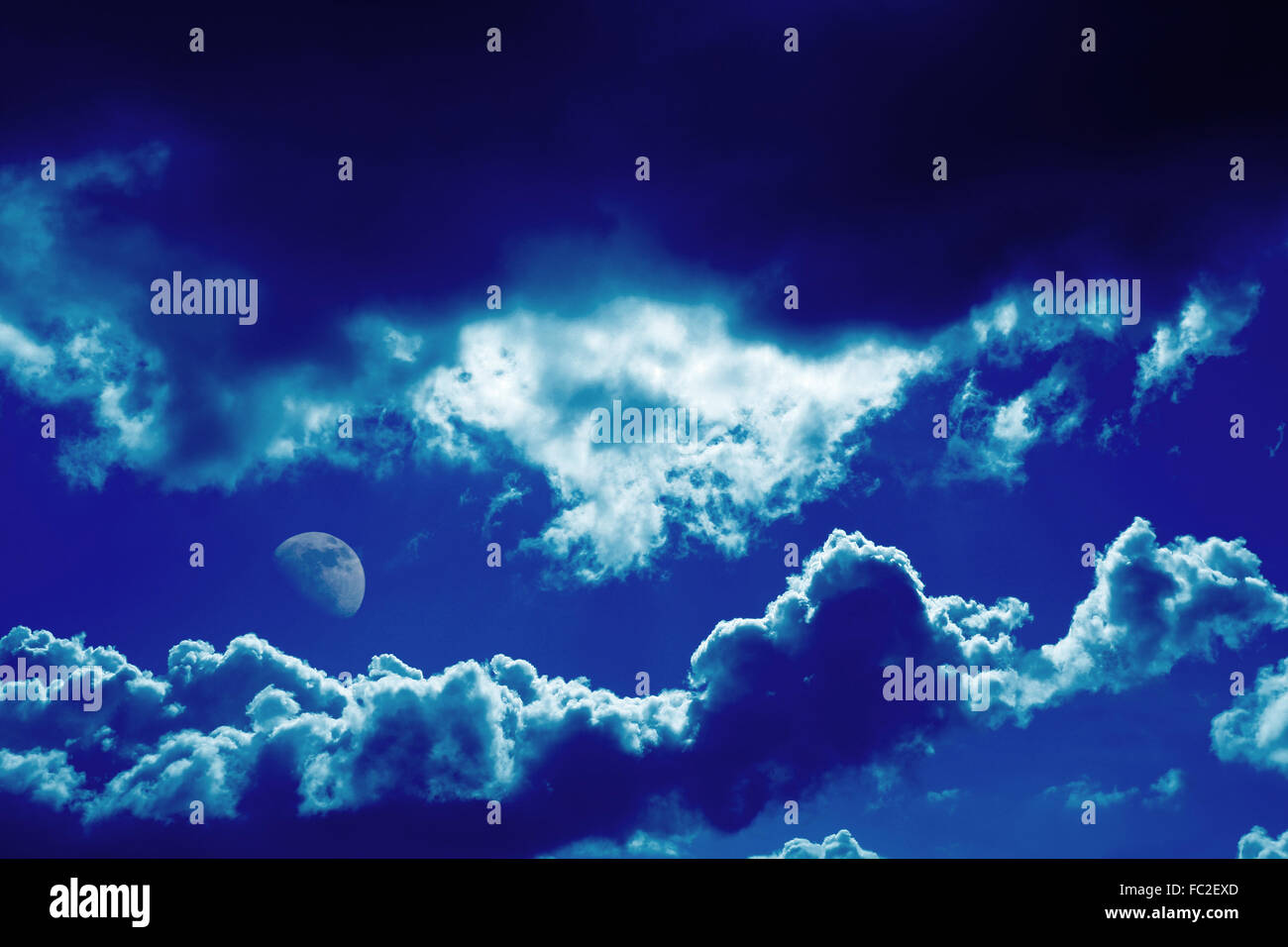 Blue clouds and moon background Stock Photo - Alamy