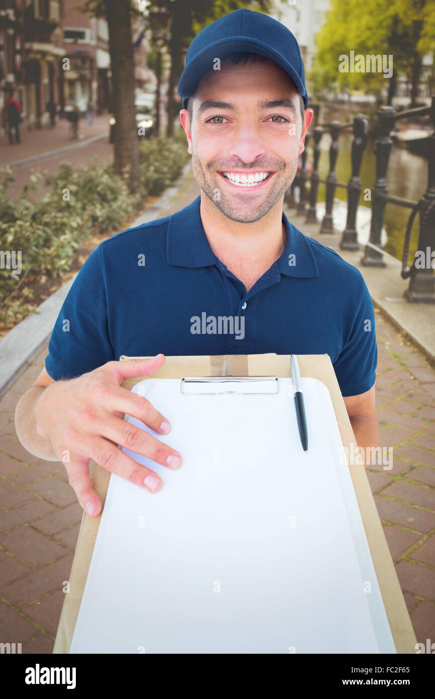 Composite image of happy delivery man with package and clipboard Stock ...