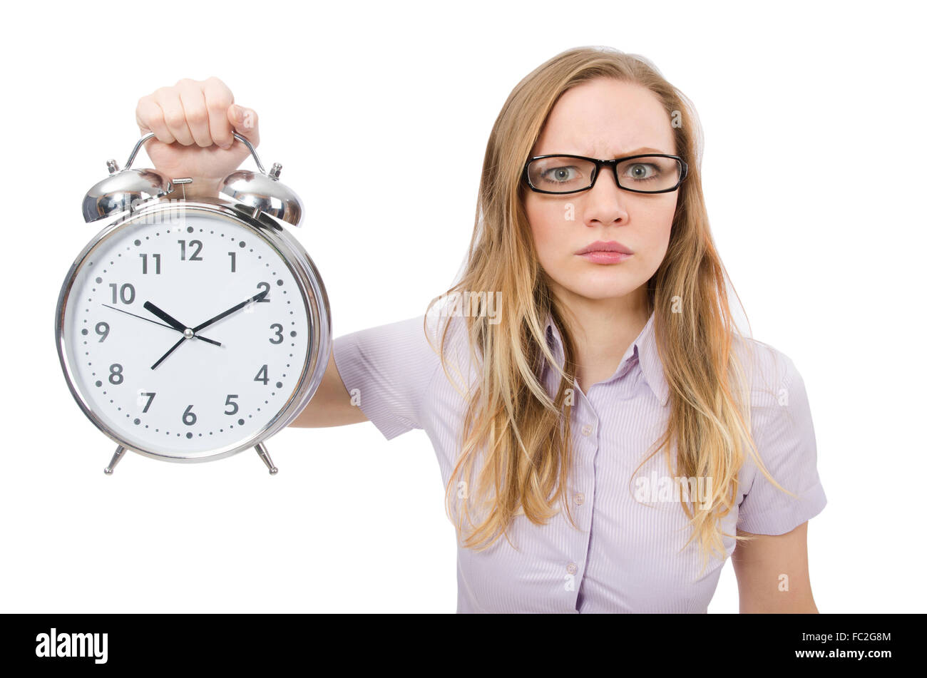 Young employee holding alarm clock isolated on white Stock Photo - Alamy