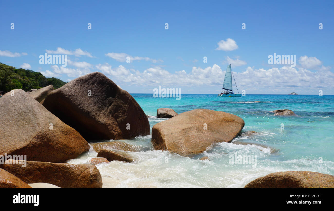 ocean rocks and sailing boat Stock Photo - Alamy