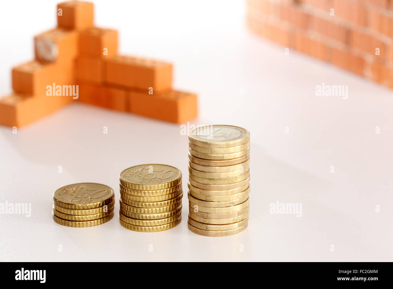 bricks and coins Stock Photo - Alamy
