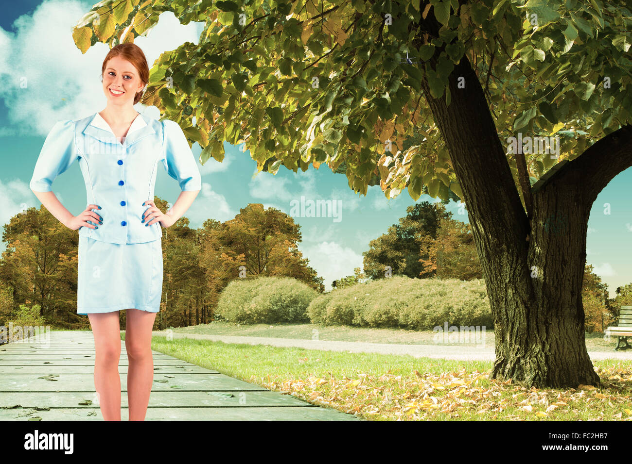 Composite image of pretty air hostess smiling at camera Stock Photo - Alamy