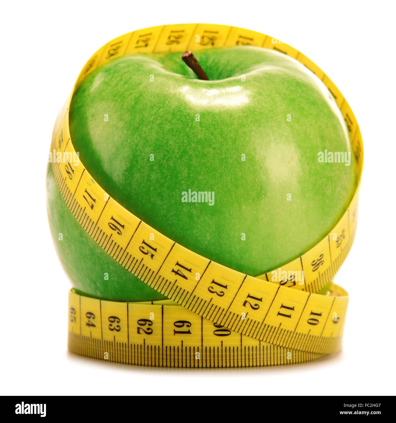 Composition with green apple and tape measure isolated on white Stock ...