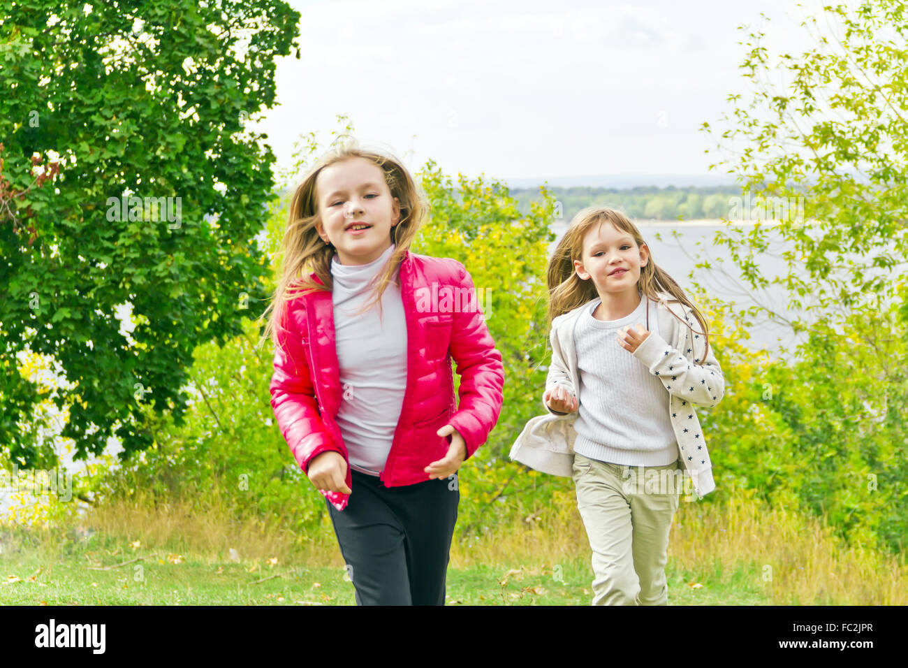 Cute two running girls Stock Photo - Alamy