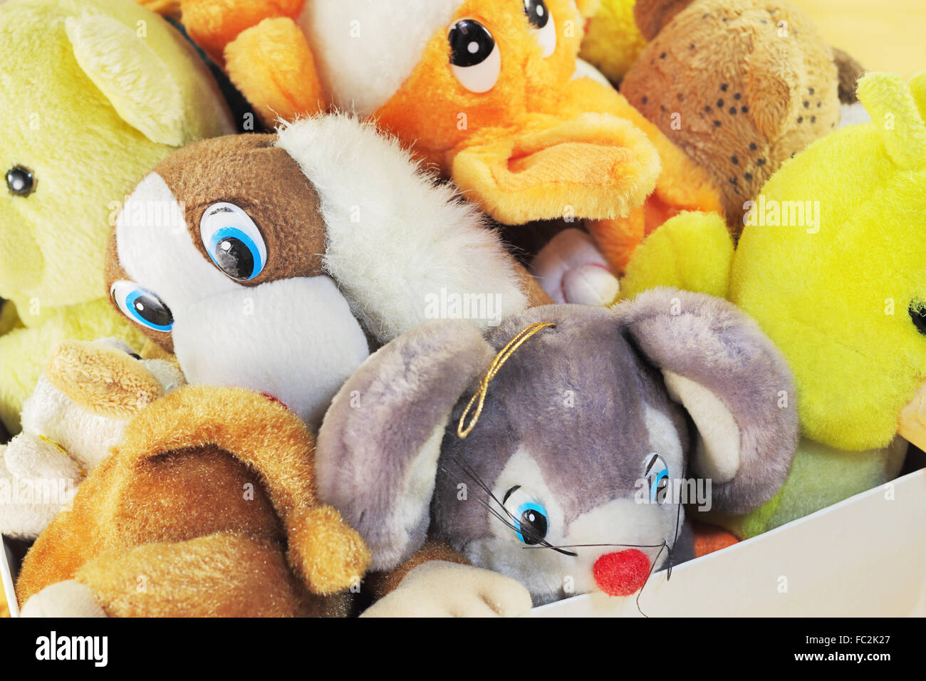 Old children's stuffed animals in a box Stock Photo - Alamy