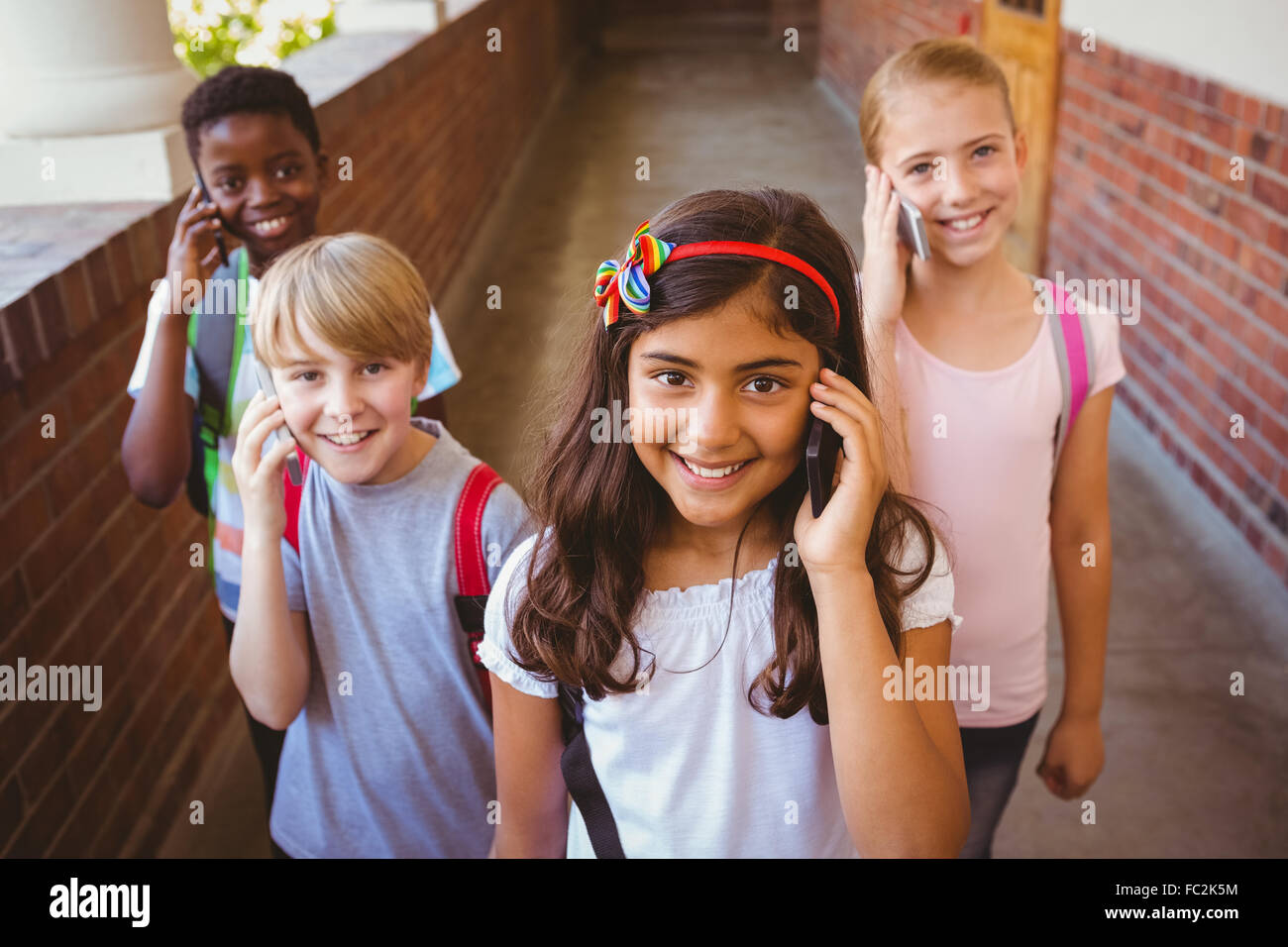 School kids using mobile phone hi-res stock photography and images - Alamy