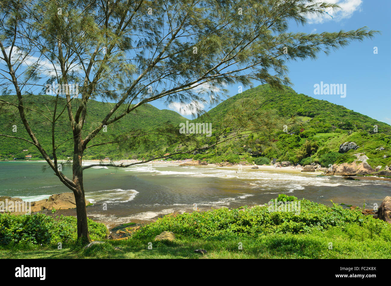 view of a beach and sky with mountains in the background in ...