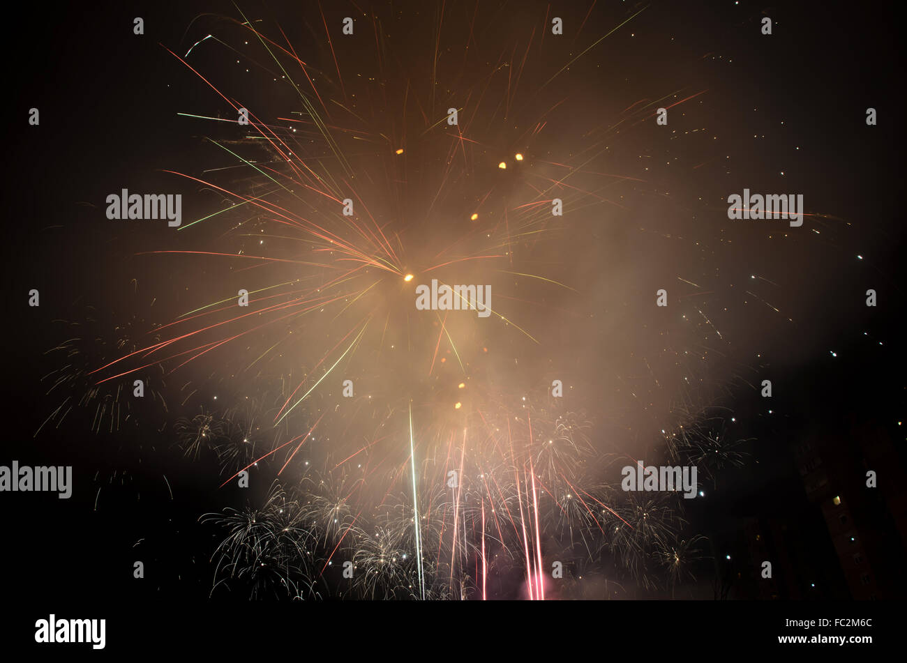 Fireworks on the dark night sky in residential area Stock Photo - Alamy