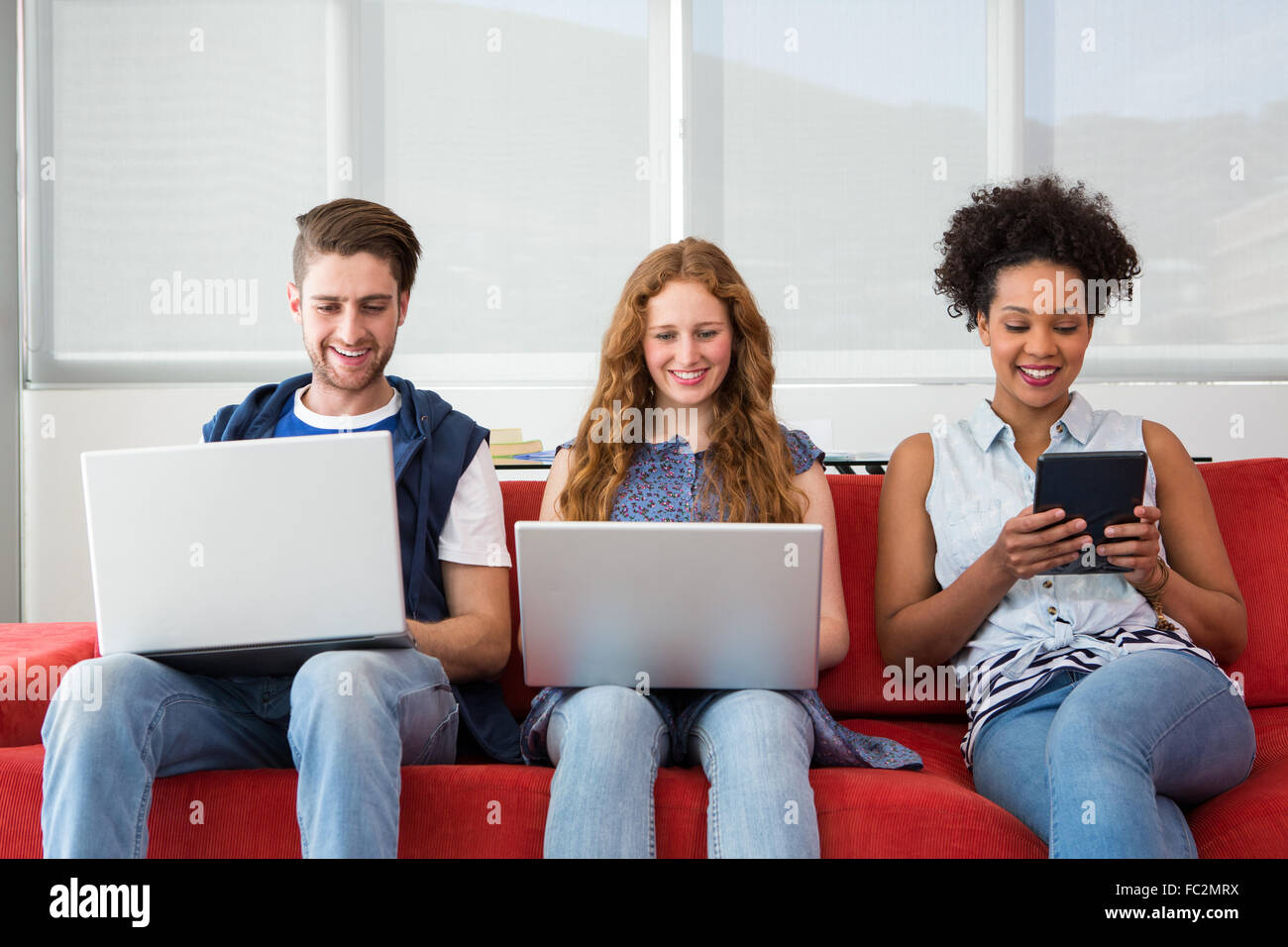 Happy creative workers laptops hi-res stock photography and images - Alamy