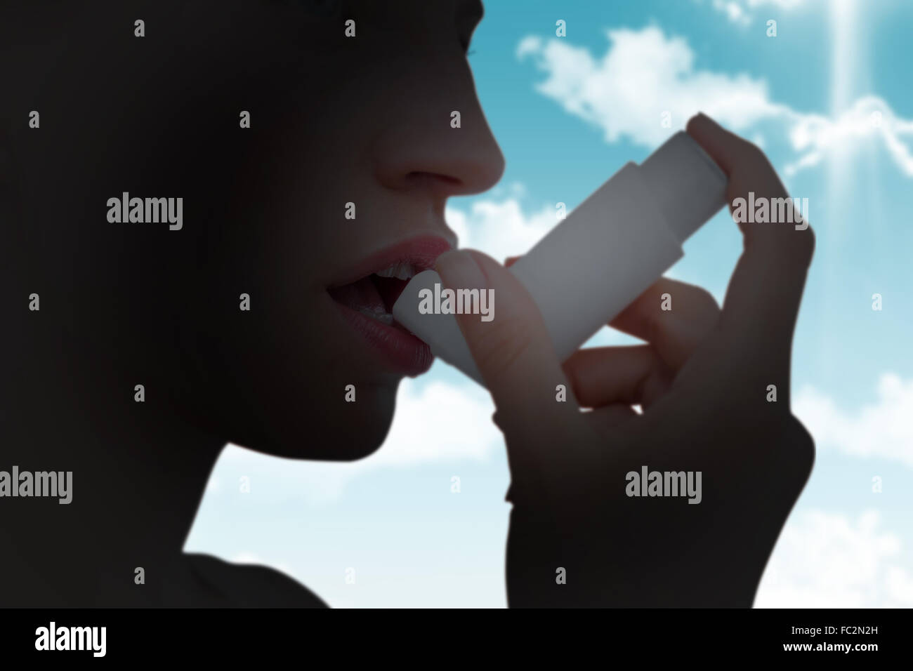 Composite image of blonde woman taking her inhaler Stock Photo - Alamy