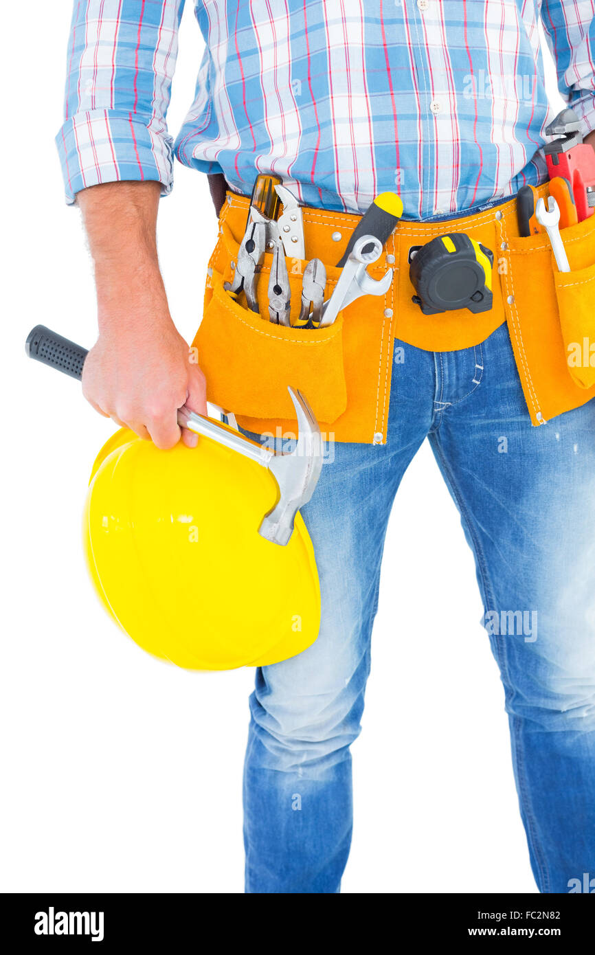 Midsection of manual worker holding hardhat and hammer Stock Photo - Alamy