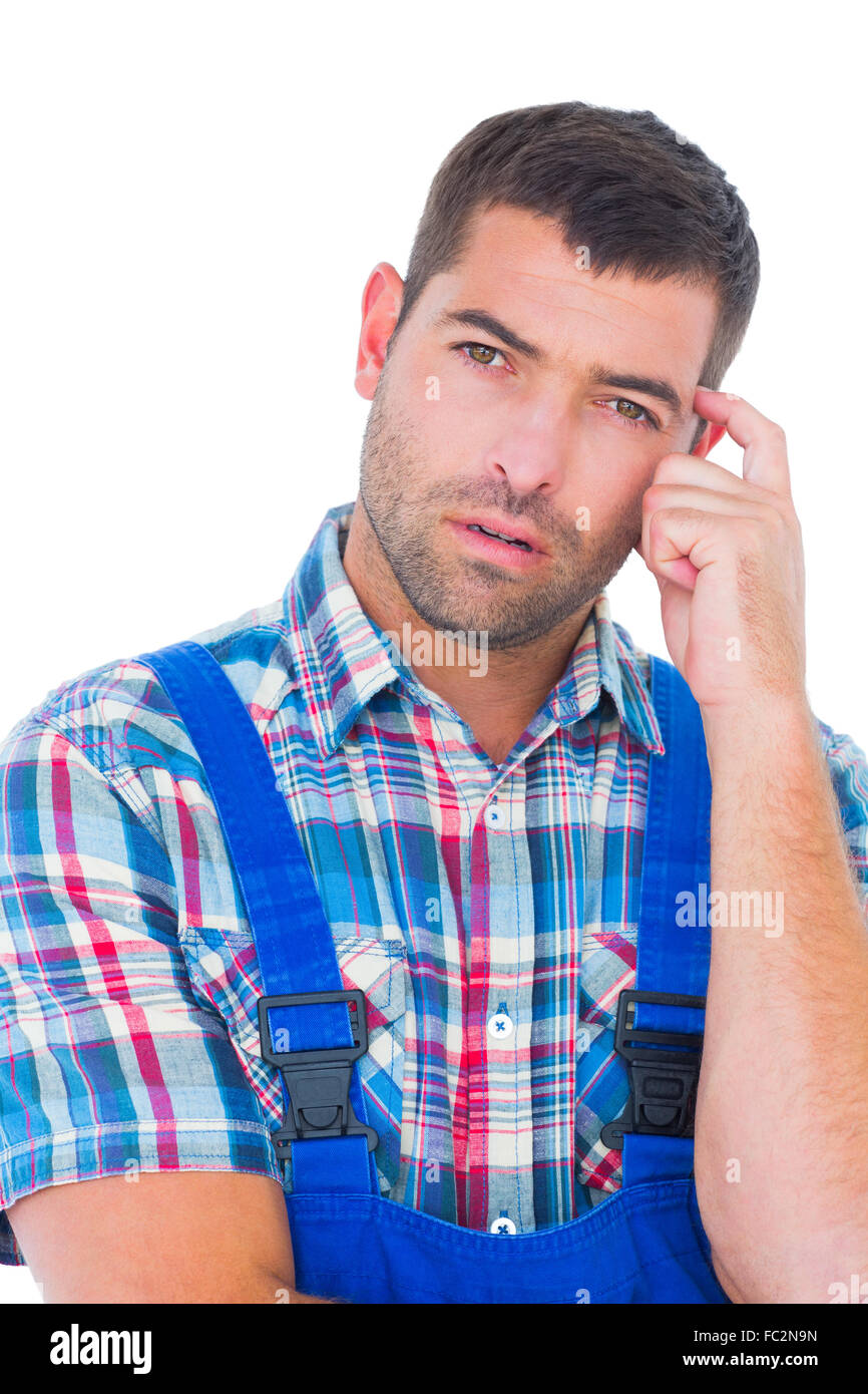 Portrait of confused manual worker scratching head Stock Photo - Alamy