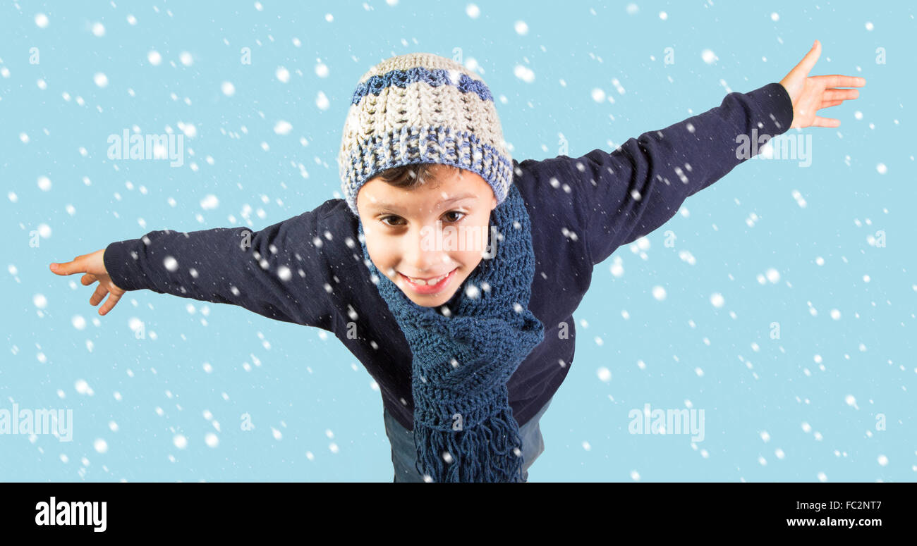 Winter - Excited little boy under falling snow Stock Photo - Alamy