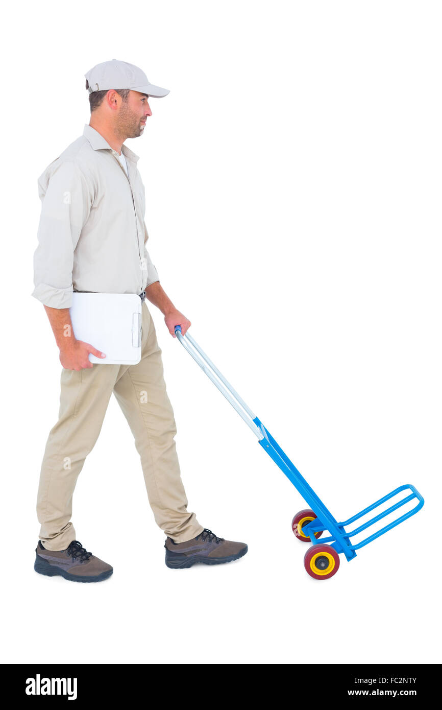 Delivery man pushing empty trolley on white background Stock Photo - Alamy