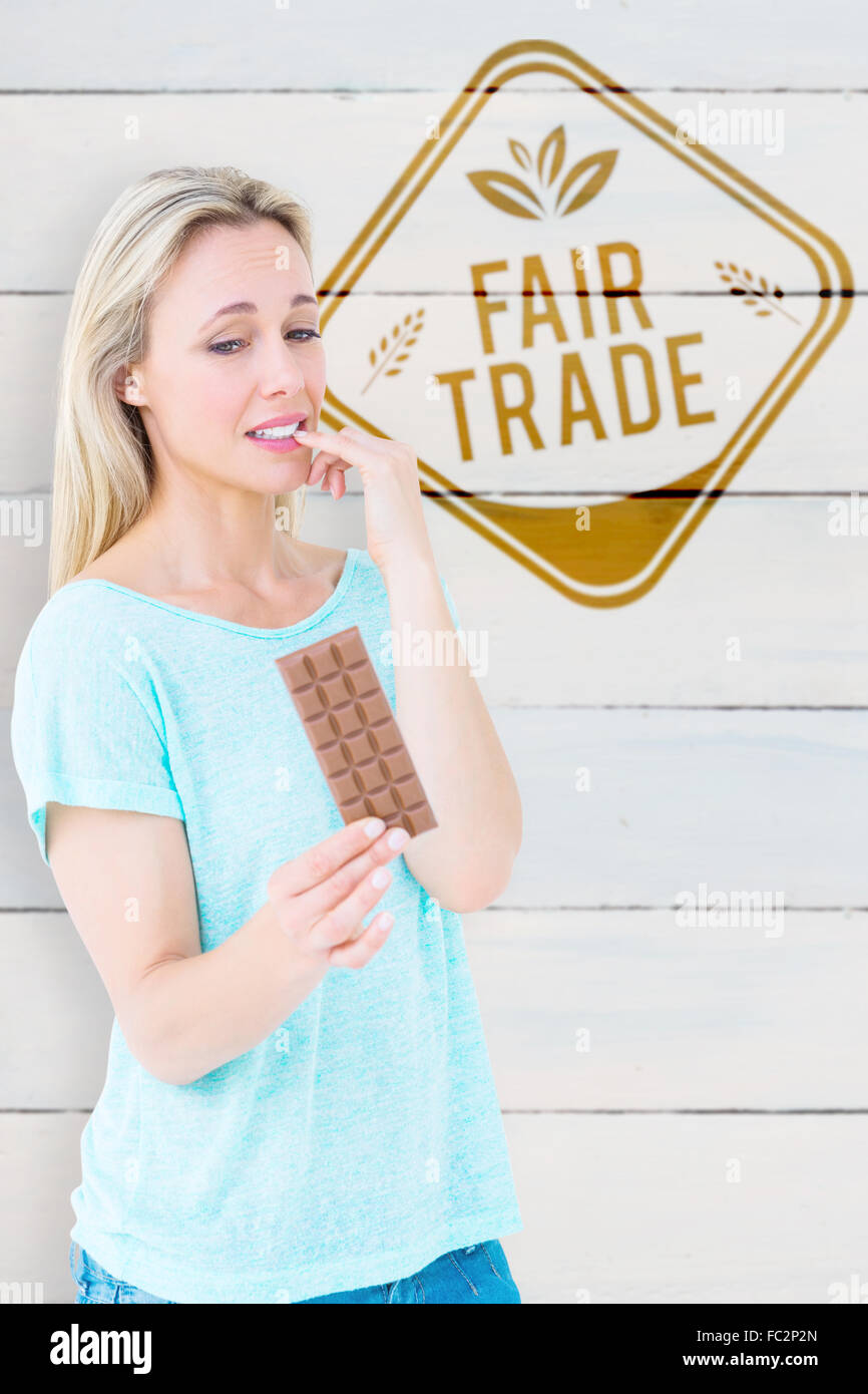 Composite image of pretty blonde feeling guilty to eat bar of chocolate ...