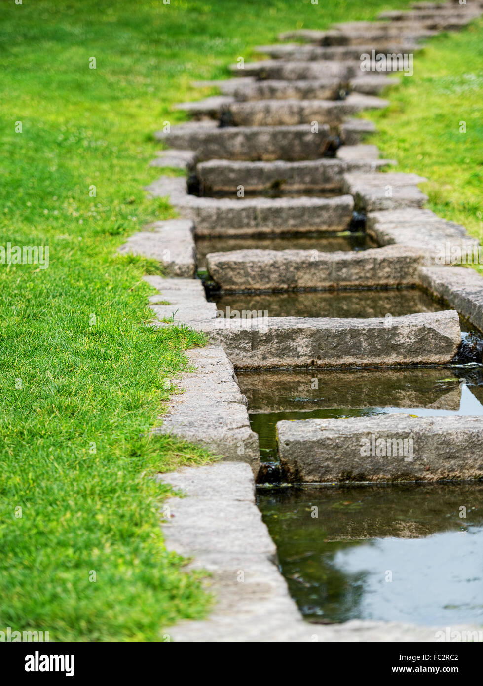 Rock installation for stream in garden Stock Photo - Alamy