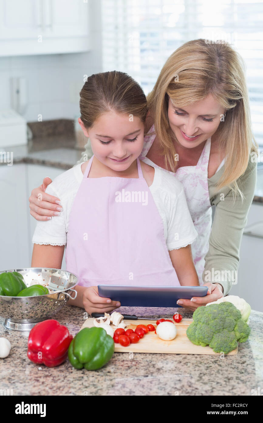Mother and daughter cooking together with tablet pc Stock Photo - Alamy