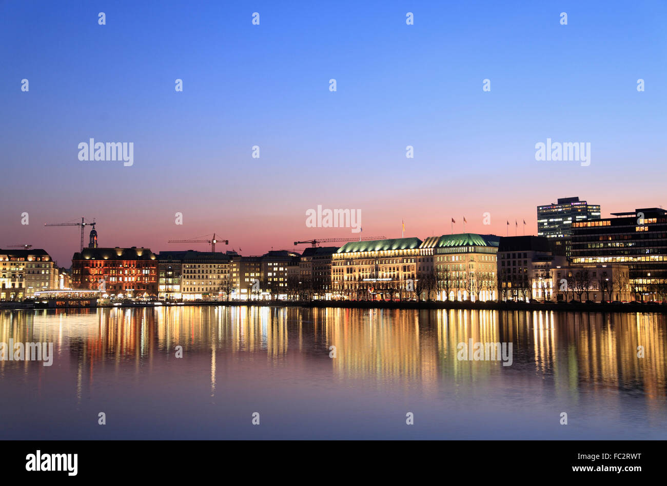 Evening view across lake Alster (Binnenalster) to Hamburg City, Germany ...